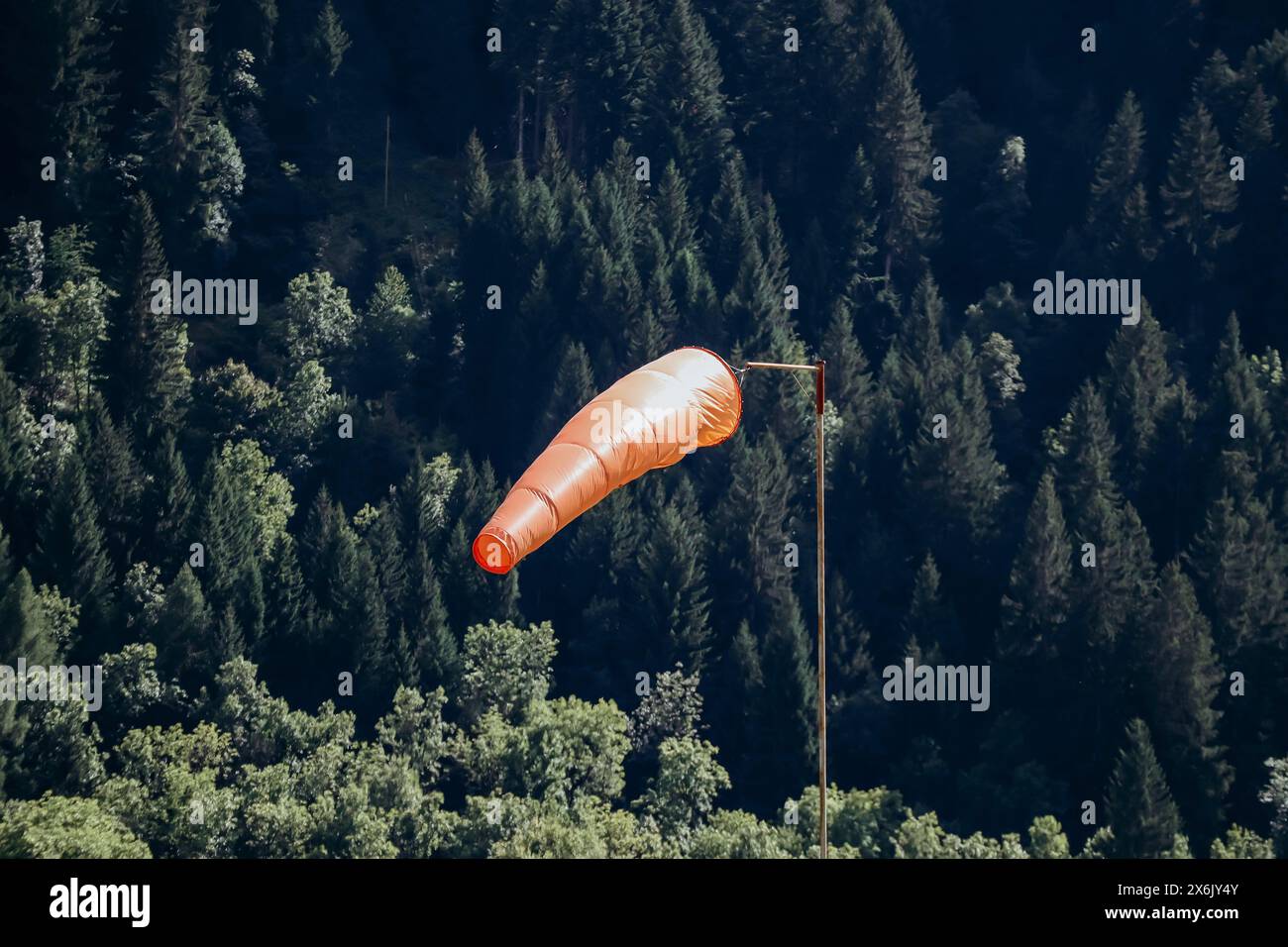 Orange wind indicator cone with mountains in the background Stock Photo ...