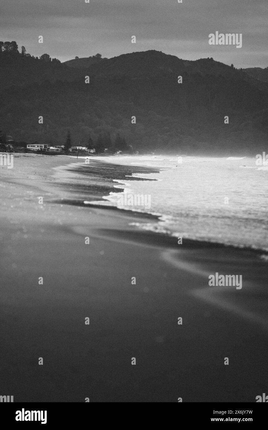 Walk on the beach at sunset, restless sea lapping waves on the beach ...