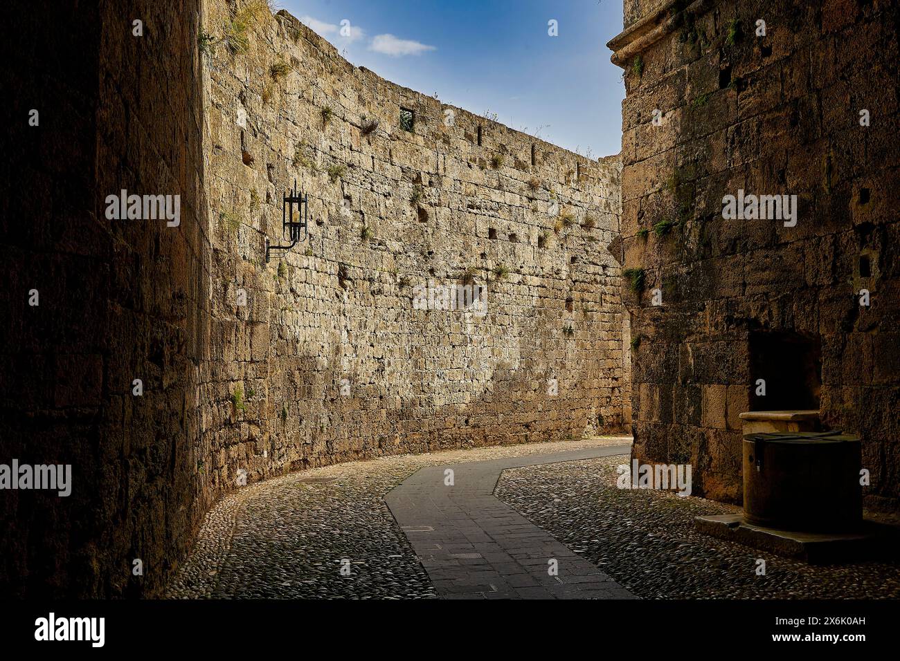 Paved path along an old fortress wall with rich stone texture, Grand ...
