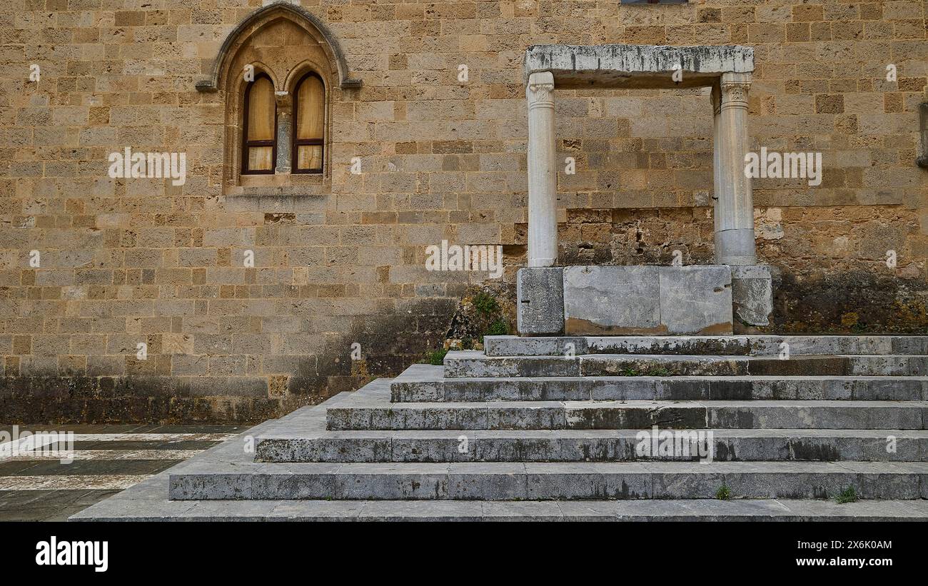 Weathered columns and steps of an ancient ruin with visible stone ...