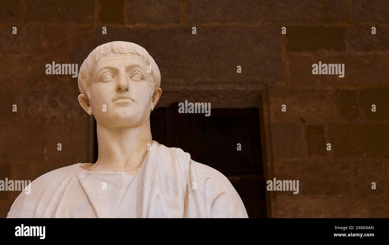 Ancient marble statue with distinct facial expression and headdress ...