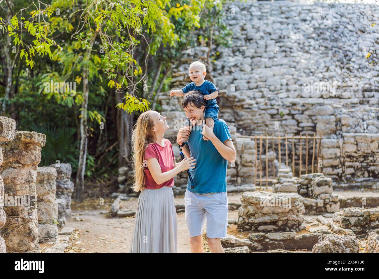 Mom, dad and baby tourists at Coba, Mexico. Ancient mayan city in ...