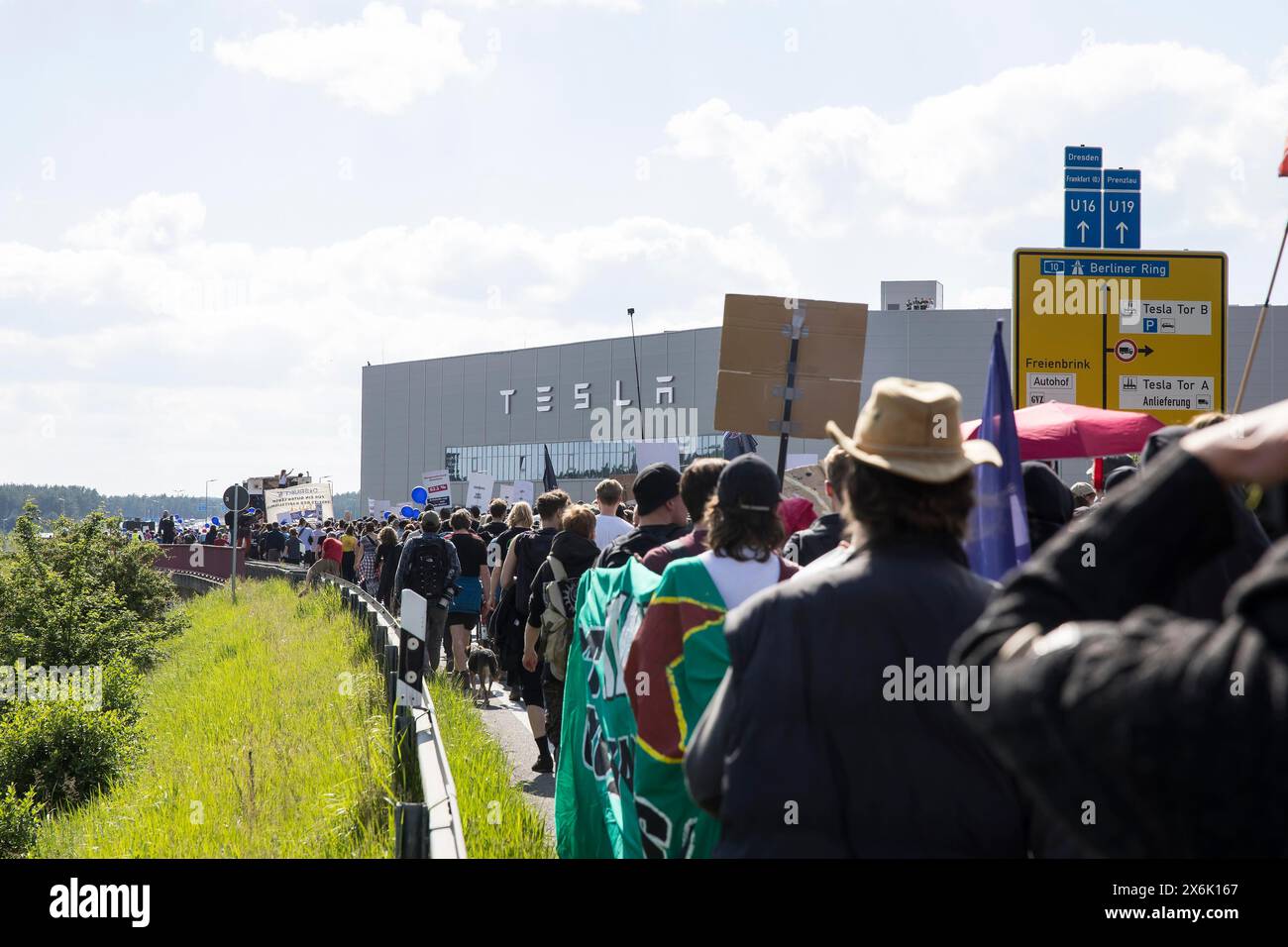 Participants walk to the Tesla Gigafactory during the demonstration ...