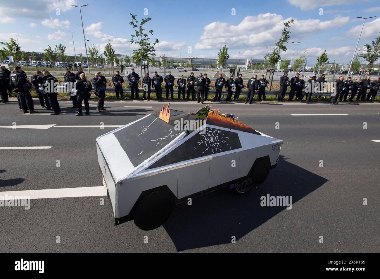 A Cybertruck cardboard model in front of the factory premises guarded ...