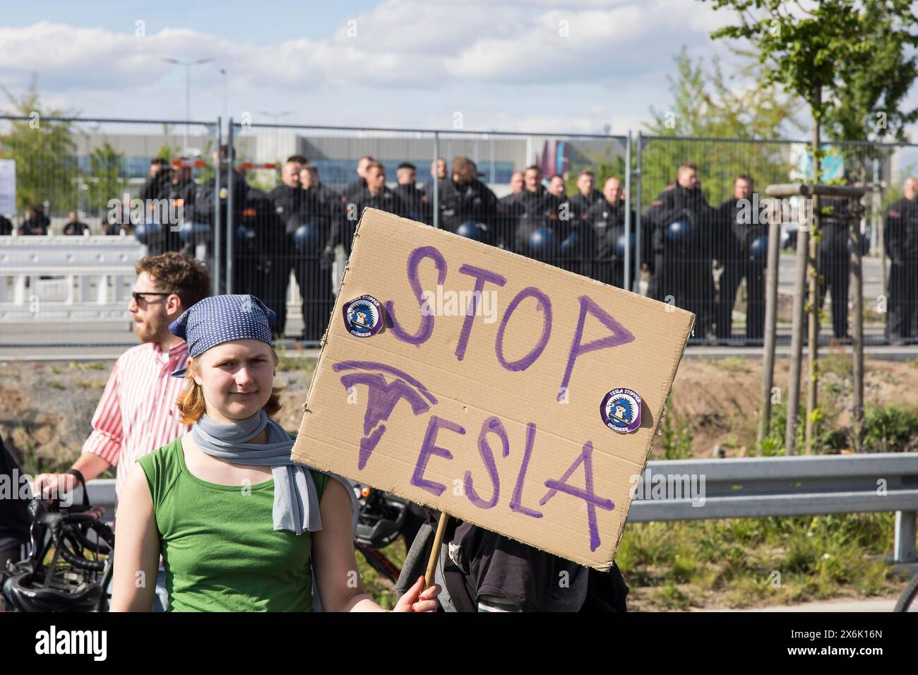 Participant with sign Stop Tesla in front of the Tesla Gigafactory at ...