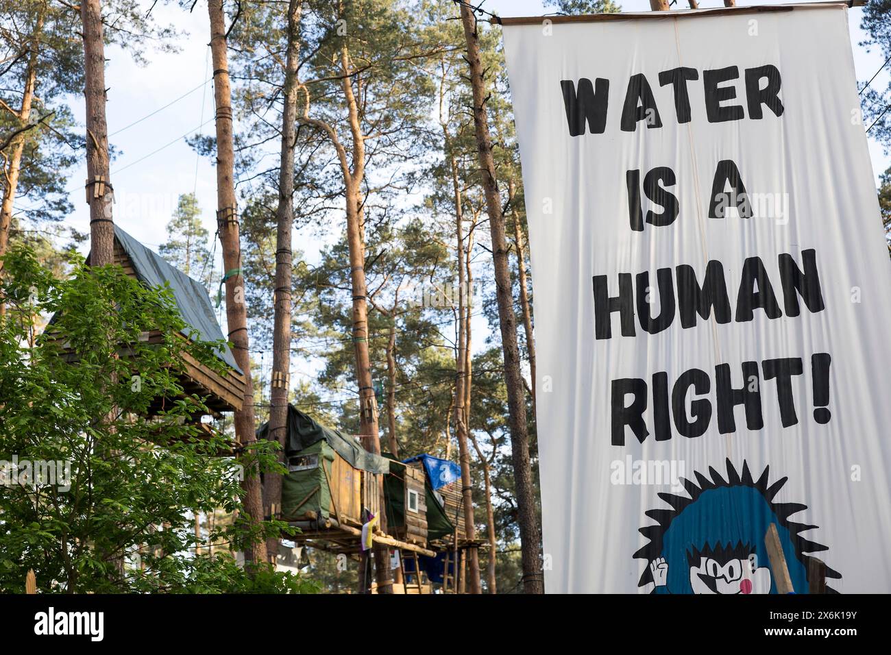 Tree houses and banners Water is a human right! (Water is a human right ...