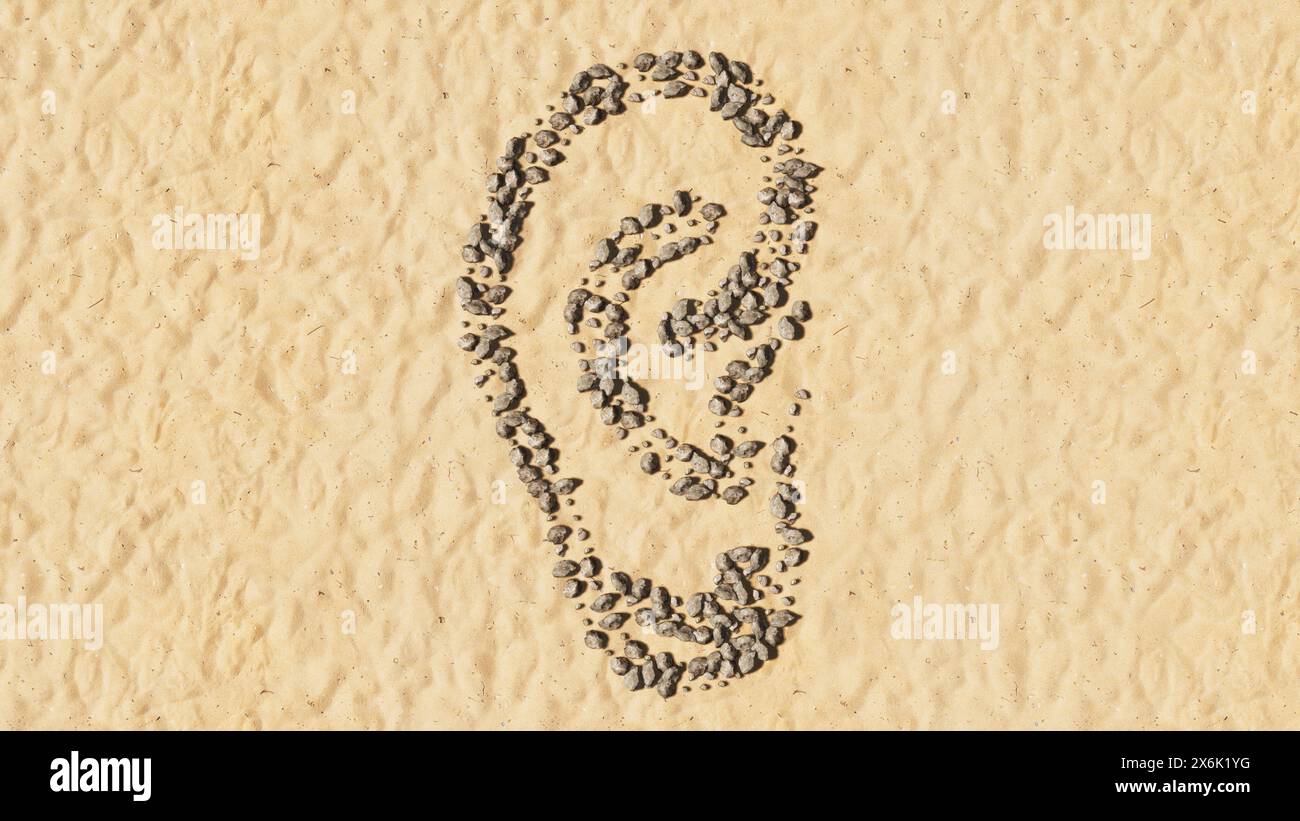 Conceptual stones on beach sand handmade symbol shape, golden sandy ...