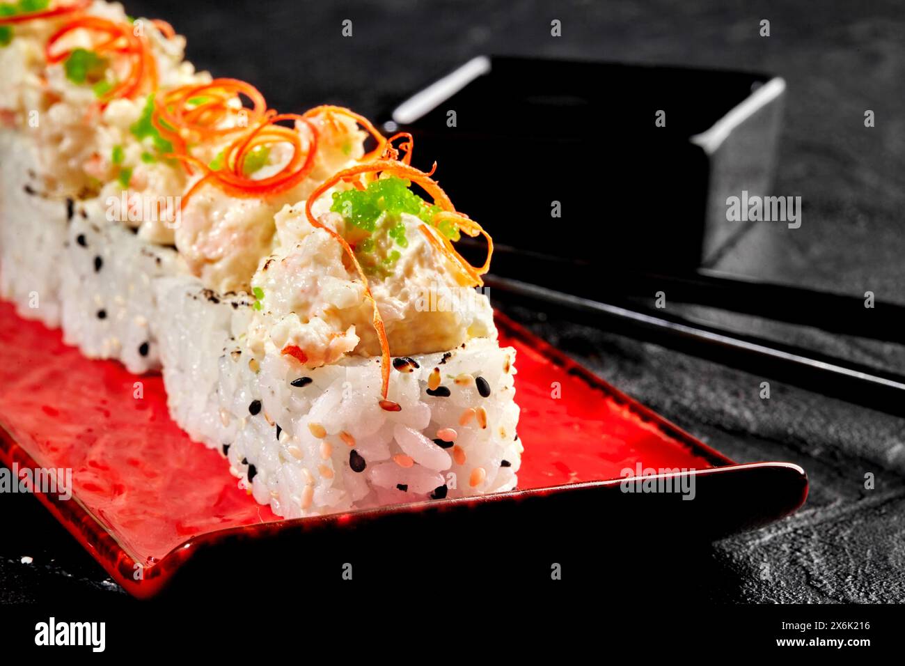 Sesame coated roll with creamy seafood topping and green tobiko Stock ...