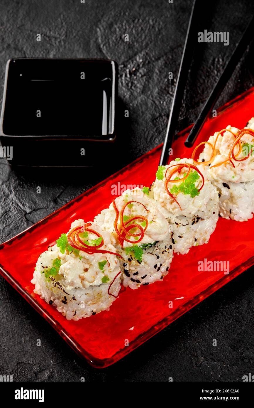 Sesame coated sushi rolls with creamy seafood caps Stock Photo - Alamy