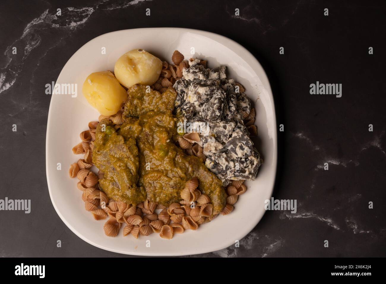 traditional bolivian food called "falso conejo" (fake rabbit), on black ...