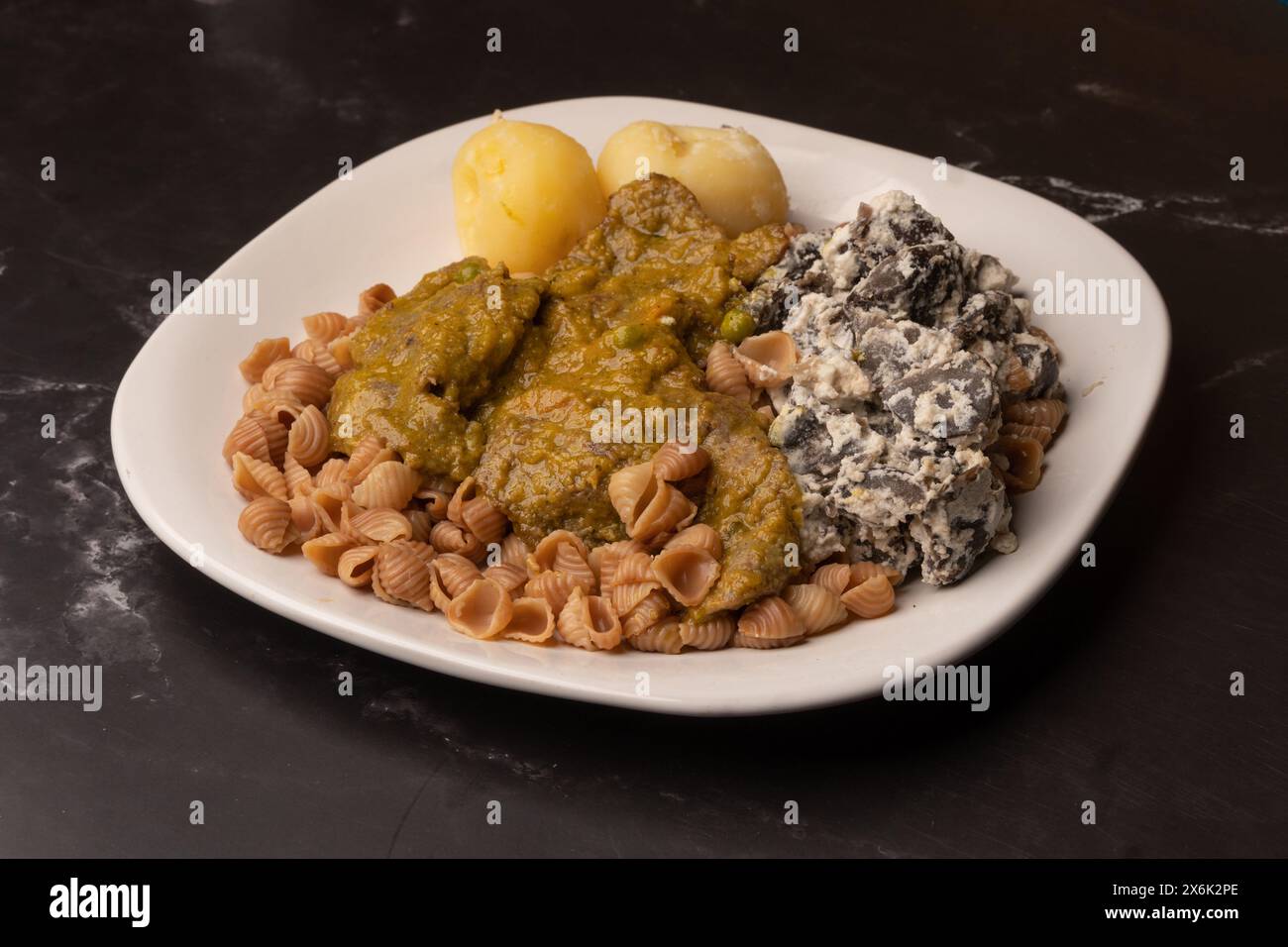 traditional bolivian food called "falso conejo" (fake rabbit), on black ...