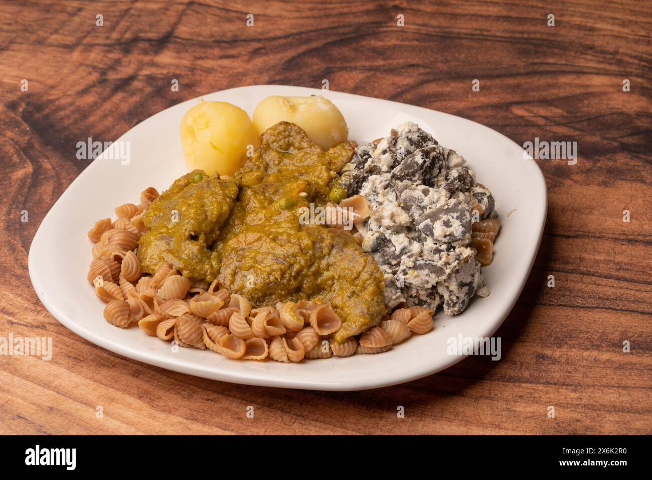 traditional bolivian food called "falso conejo" (fake rabbit), on black ...