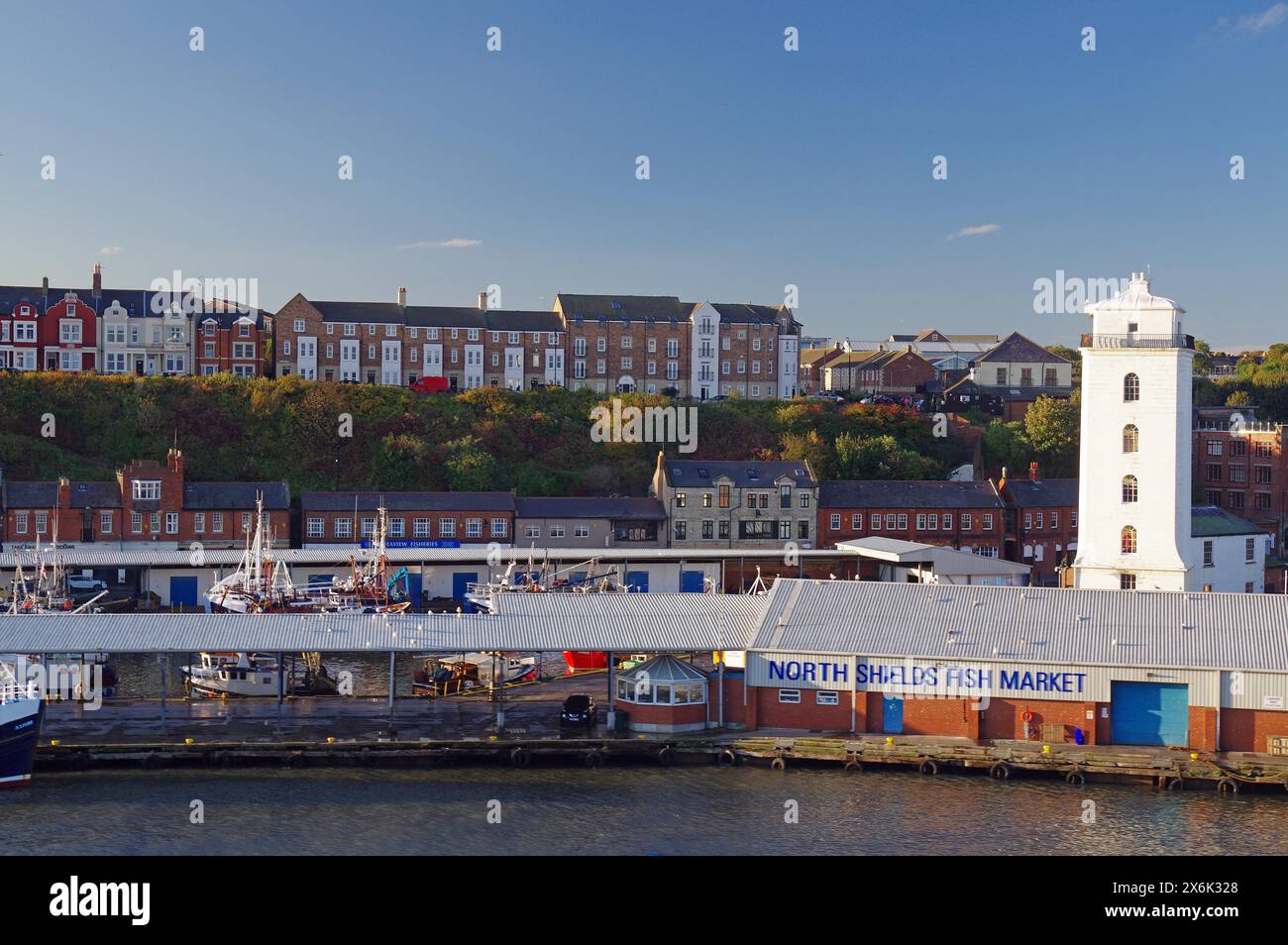 Residential houses, lighthouse and old warehouses at the harbour of ...