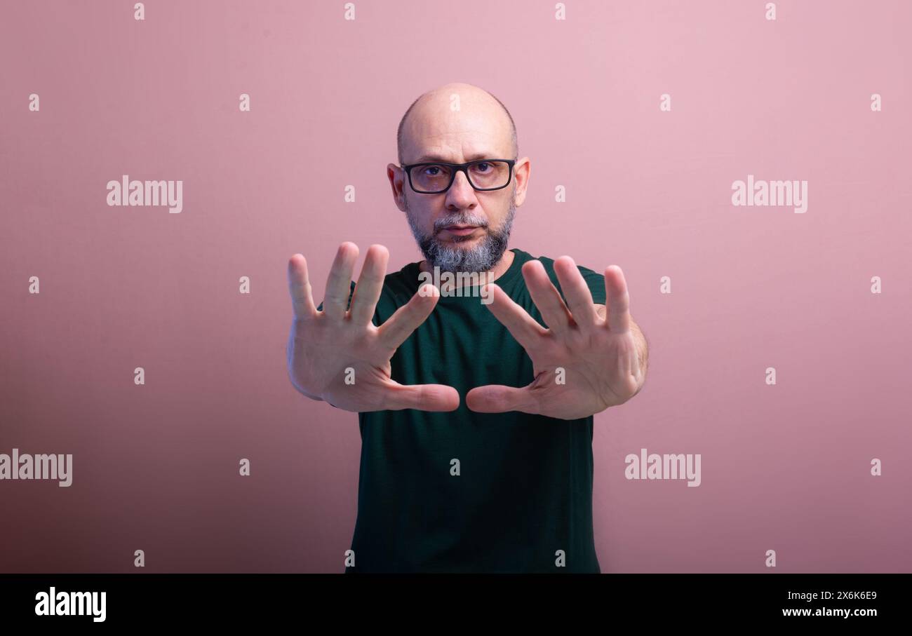 Portrait Of Bald Bearded Man Wearing Prescription Glasses Showing His