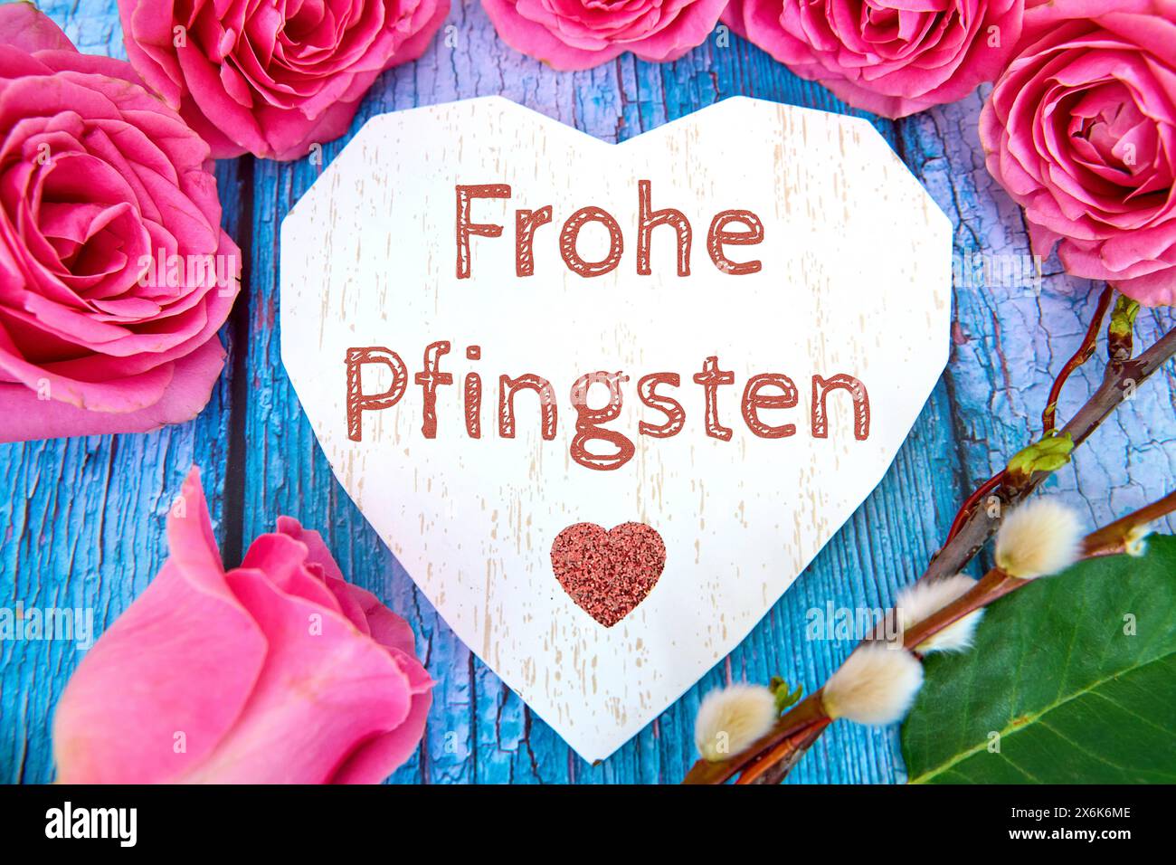 15 May 2024: Wooden heart surrounded by pink roses with the text: Happy ...