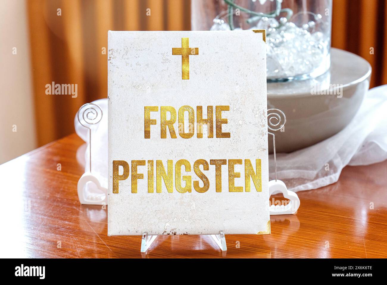 15 May 2024: Happy Pentecost - lettering on a white book with a cross ...