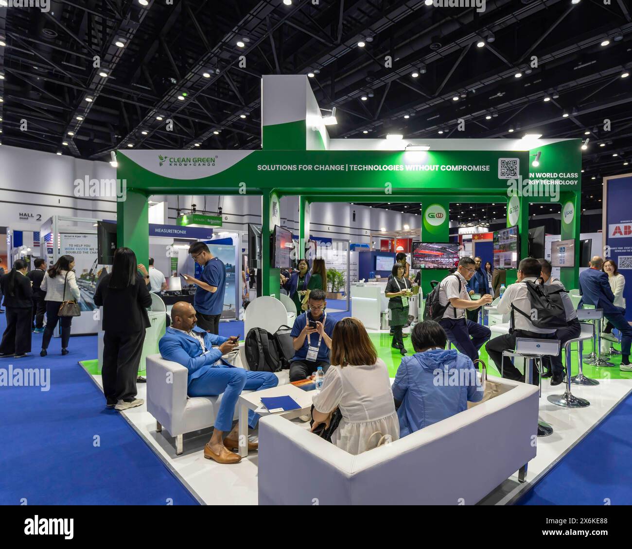 Visitors are seen relaxing at the booth of DGA Global, a company with ...