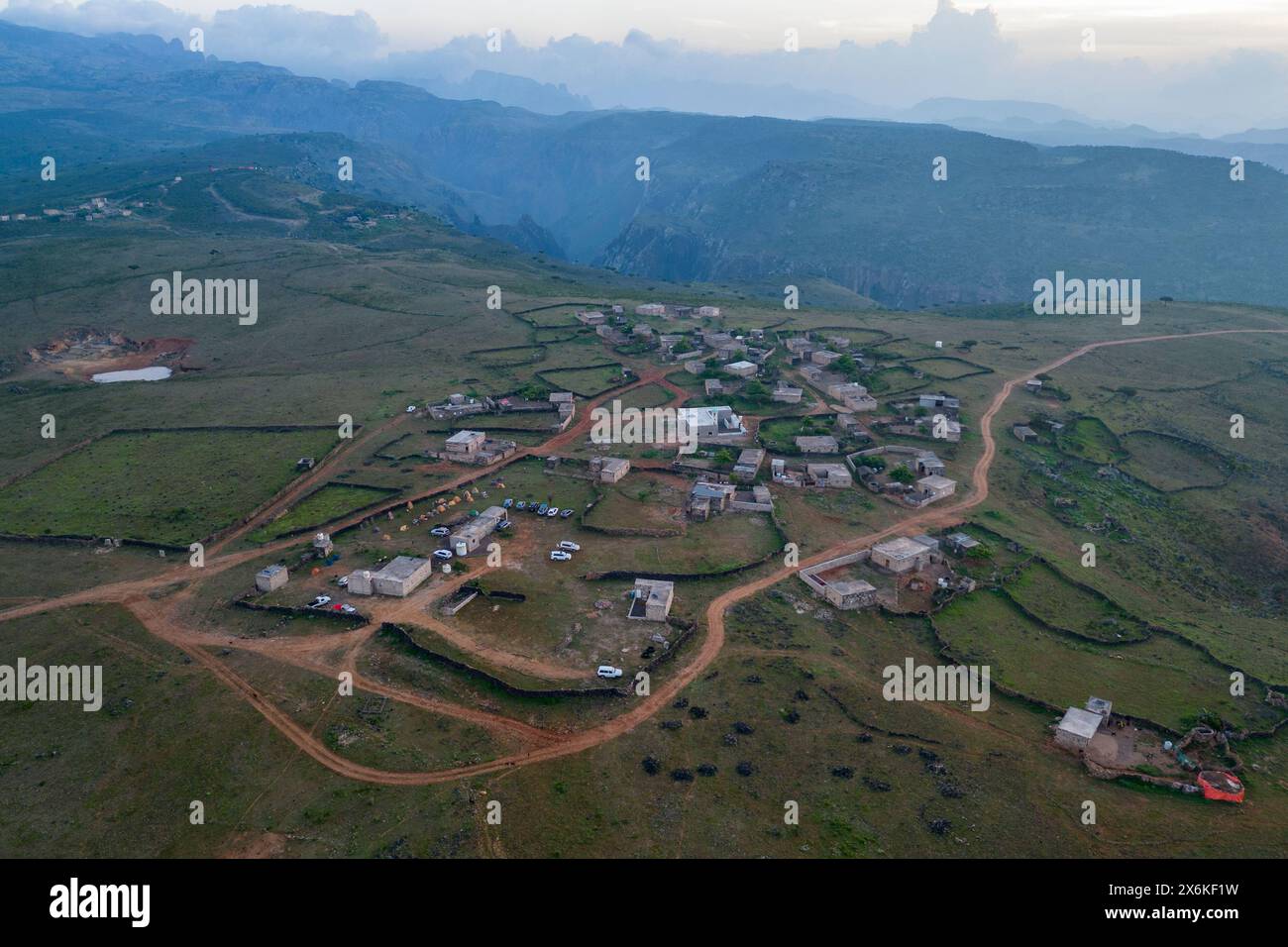 Aerial view of village on Diksam Plateau with Wadi Dirhur Canyon behind ...