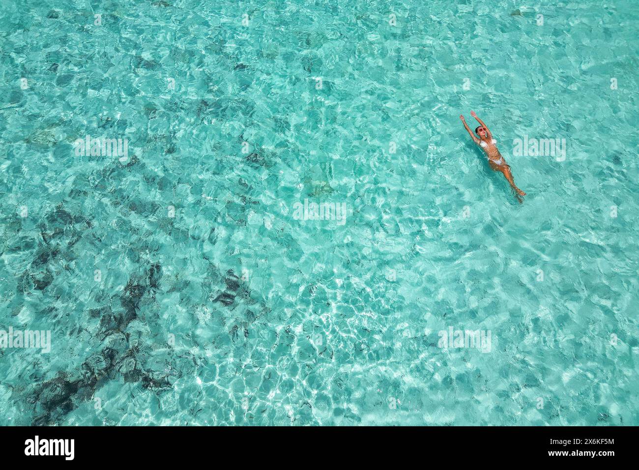 Aerial view of a woman swimming in shallow water, Assumption Island ...