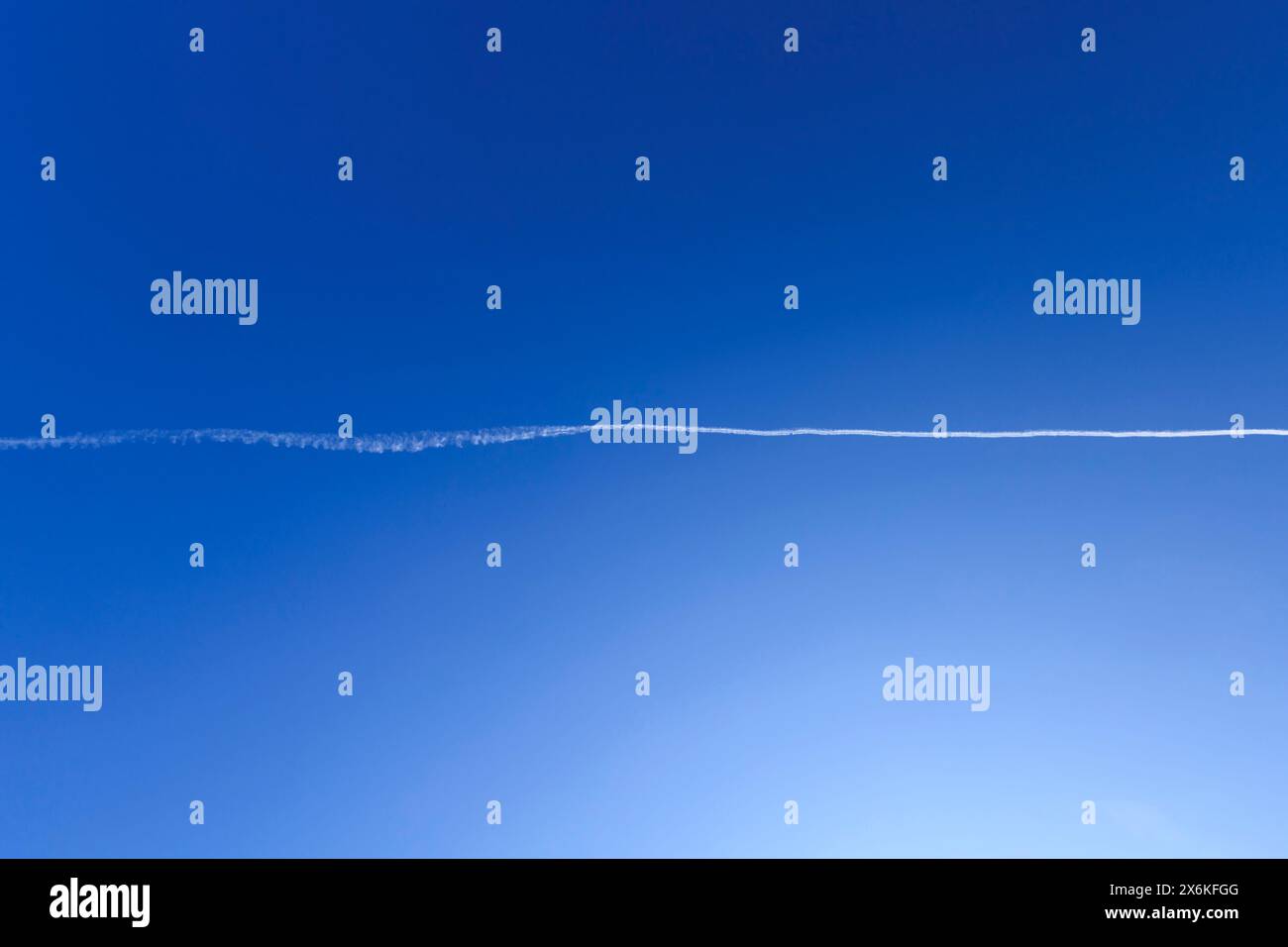 Contrail and condensation trail on the clear blue sky. Straight line by ...
