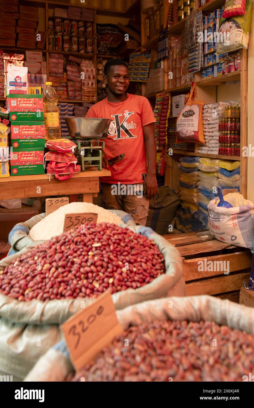 Happy man at a fruit and vegetable stall in the market hall, Chaka ...