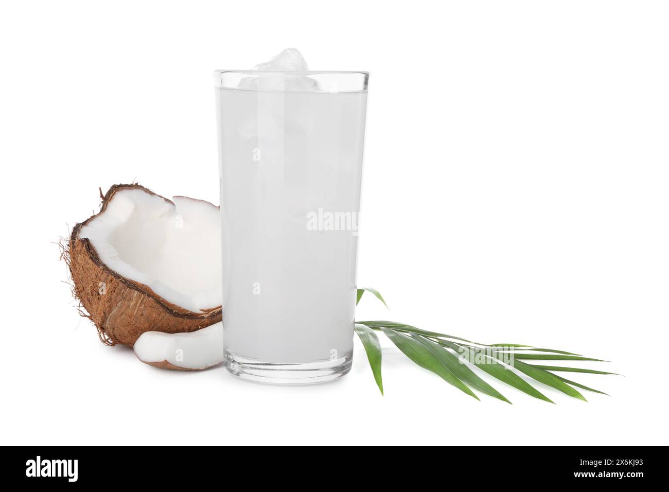 Glass of coconut water, ice cubes, leaf and nut isolated on white Stock ...