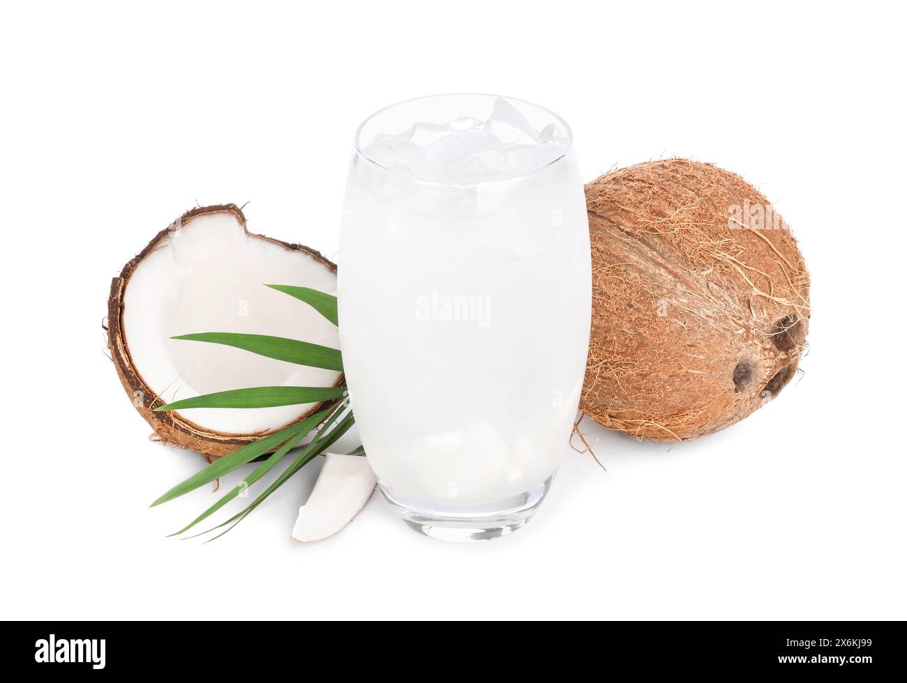Glass of coconut water, ice cubes, leaf and nuts isolated on white ...