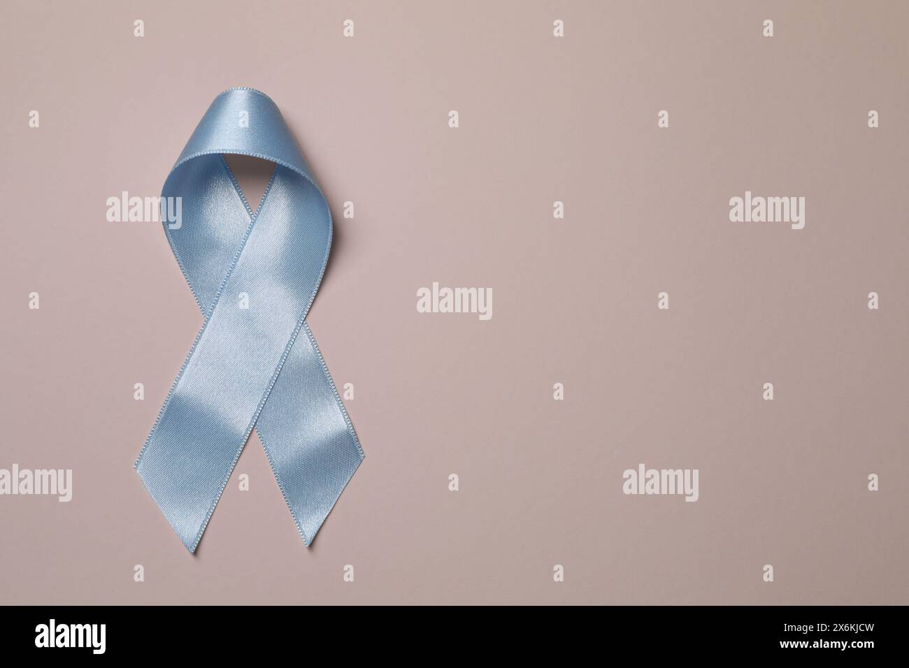 International Psoriasis Day. Light blue ribbon as symbol of support on ...