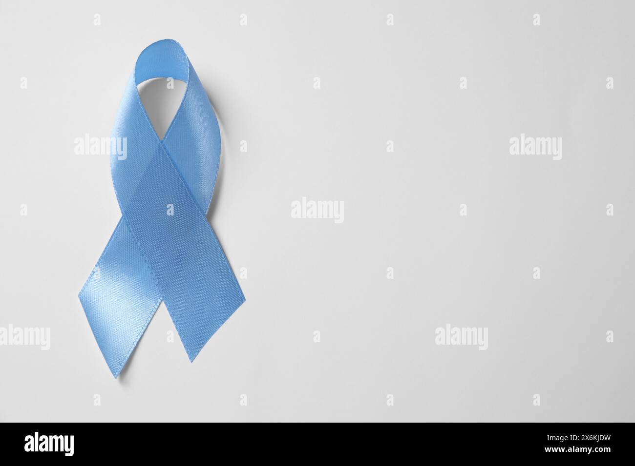 International Psoriasis Day. Light blue ribbon as symbol of support on ...