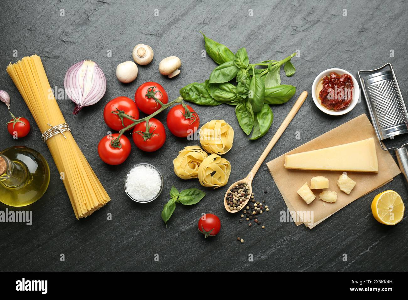 Different types of pasta, spices, garter and products on dark textured ...
