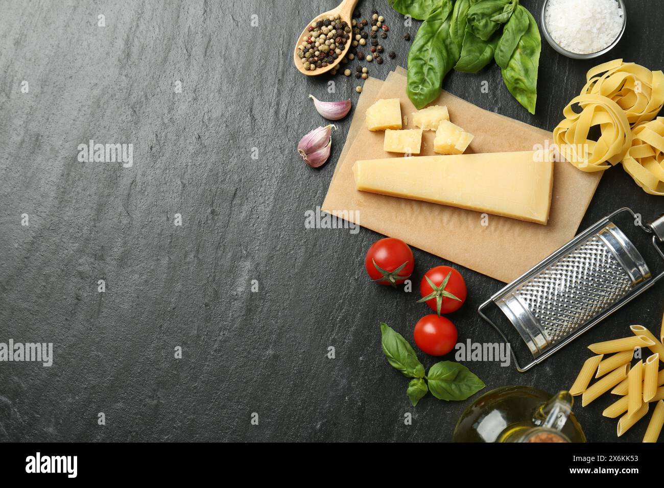 Different types of pasta, spices, garter and products on dark textured ...