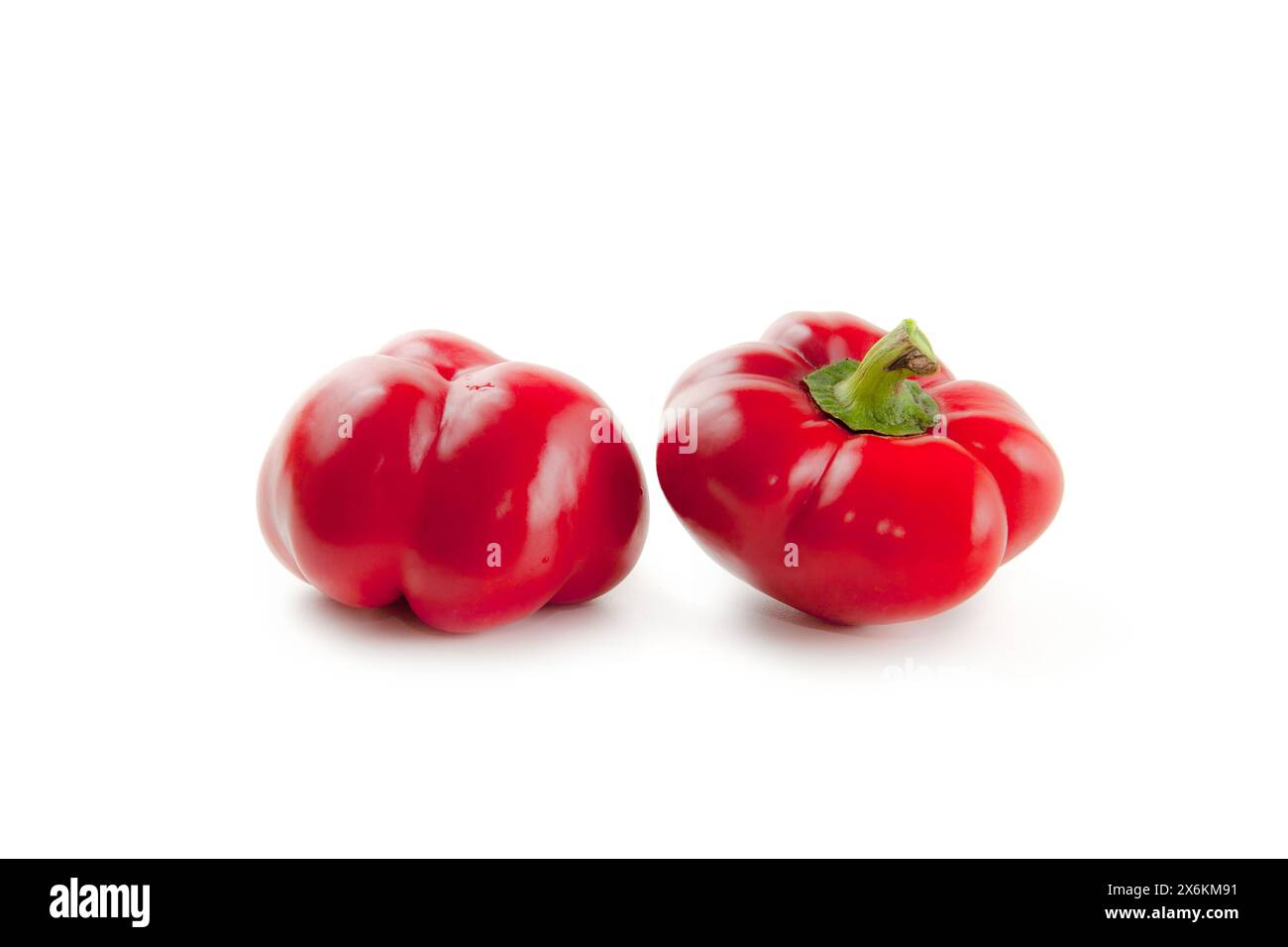 Two round red bell pepper (capsicum) known as sweet bell pepper ...