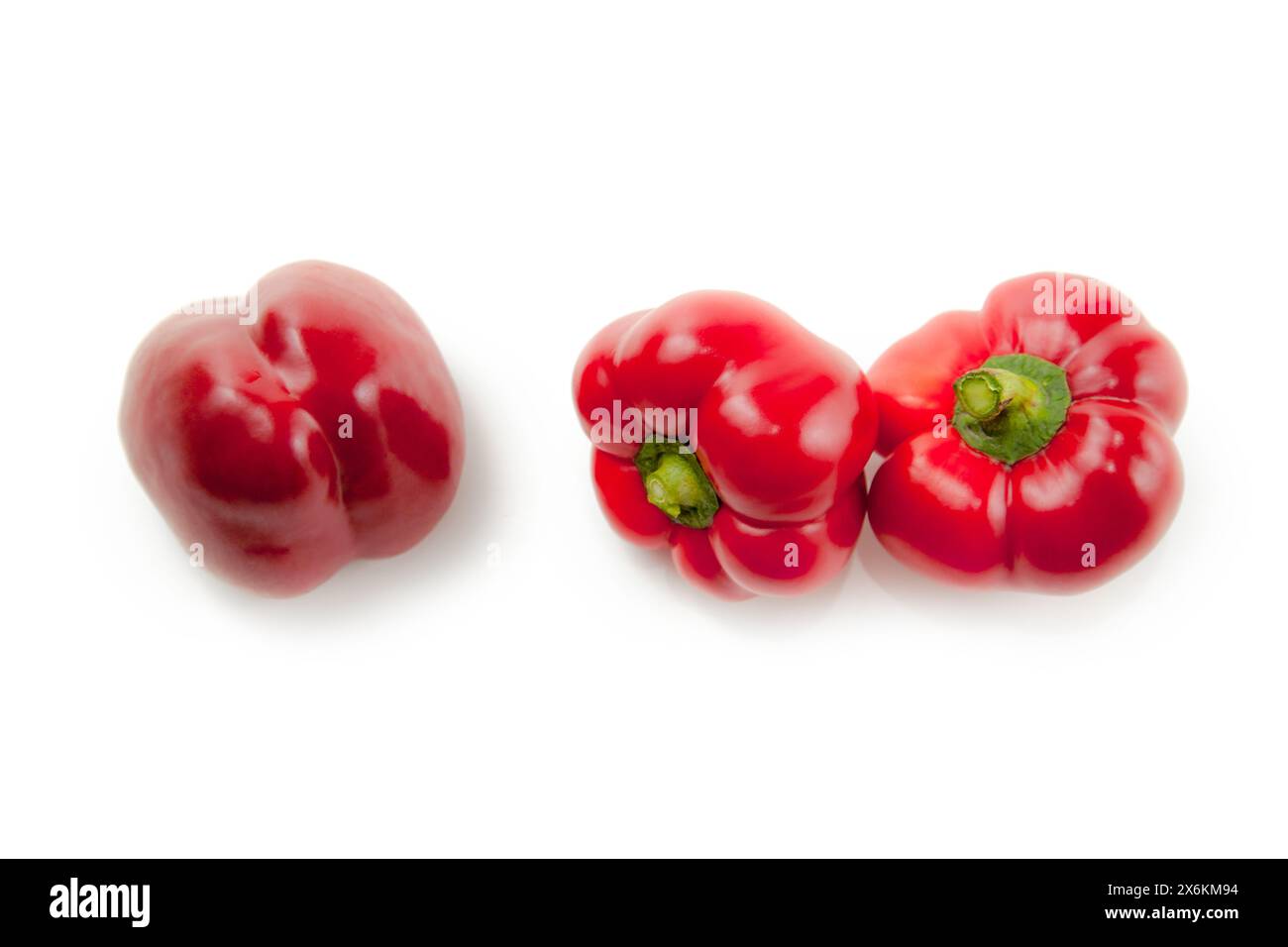 Three round red bell pepper (capsicum) known as sweet bell pepper ...