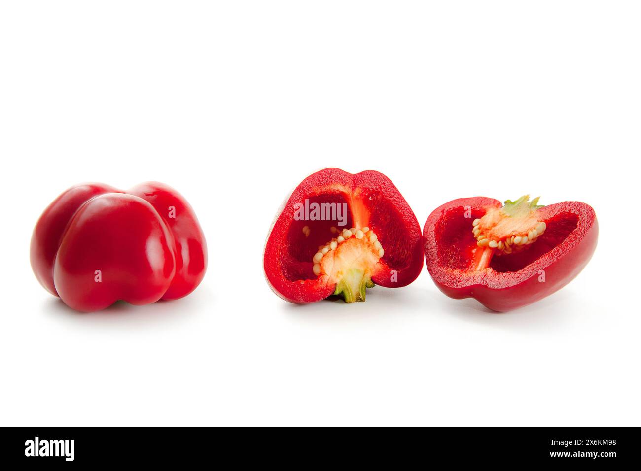 Whole and half of red bell pepper (capsicum) known as sweet bell pepper ...