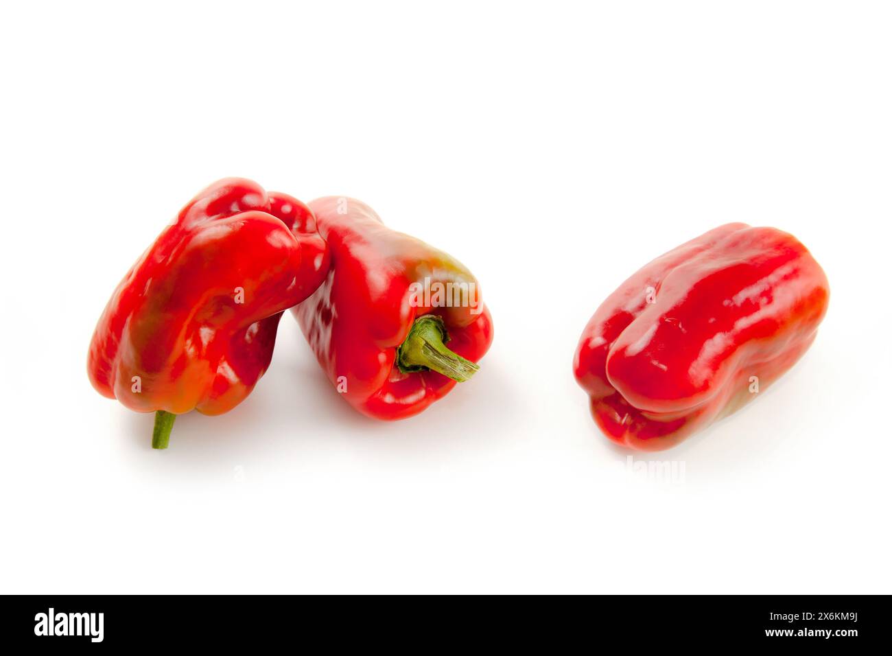 Three whole red bell pepper (capsicum) known as sweet bell pepper ...