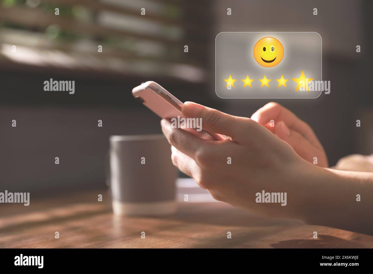Woman leaving service feedback with smartphone at home, closeup. Stars ...