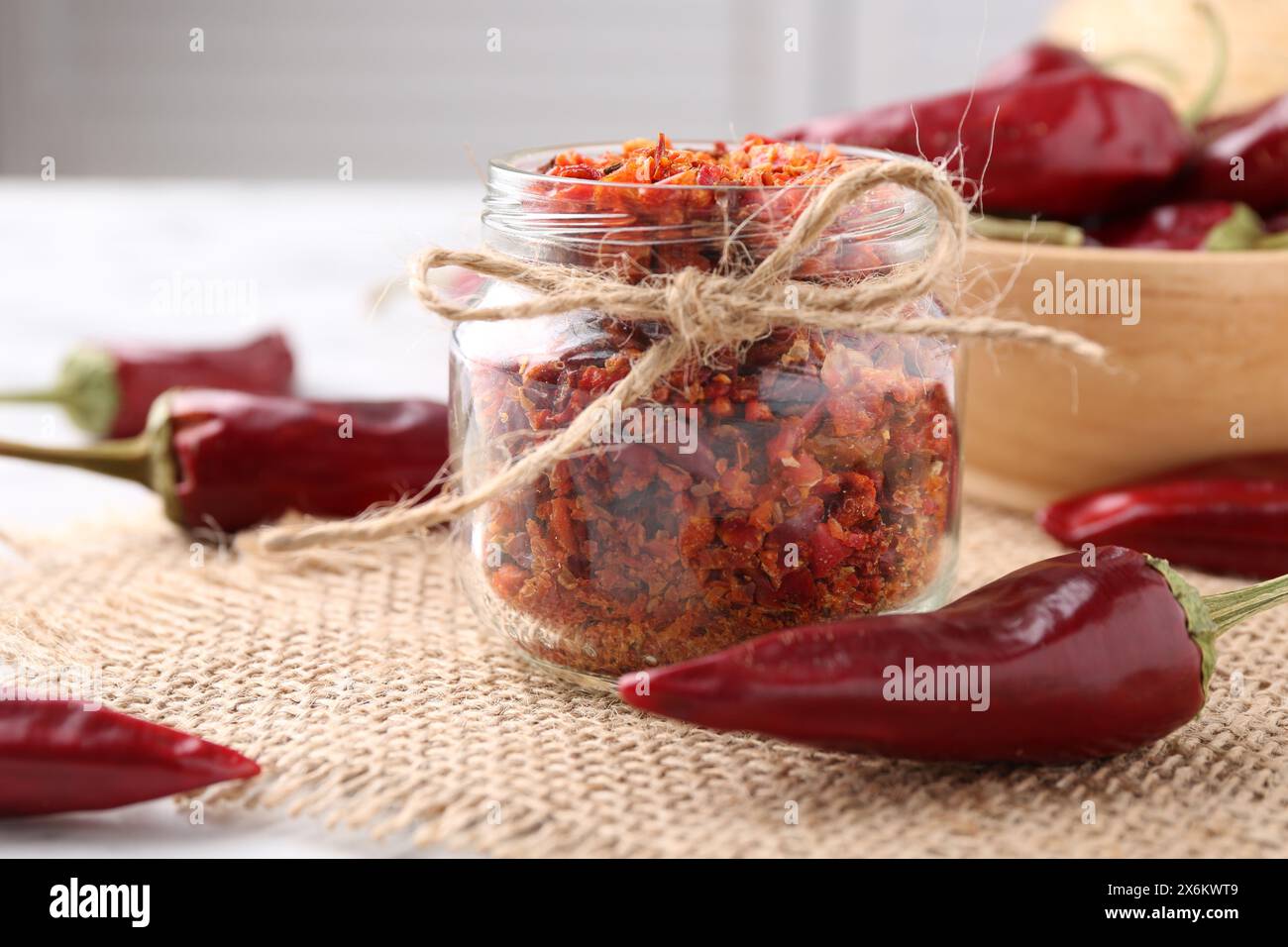 Chili pepper flakes and pods on table, closeup Stock Photo - Alamy