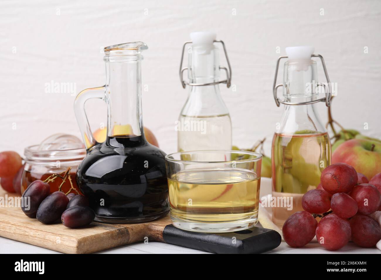 Different types of vinegar and fresh fruits on table Stock Photo - Alamy