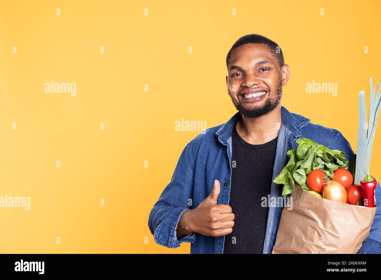 Charismatic friendly guy shows like gesture in studio, giving a thumbs ...