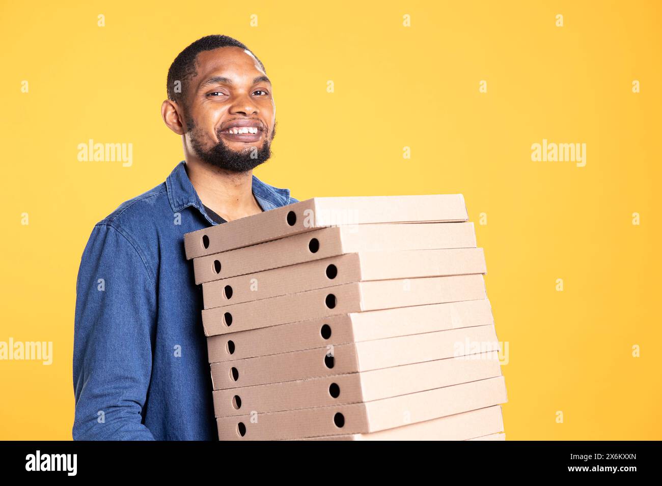 African american courier carrying huge stack of pizza boxes to deliver ...