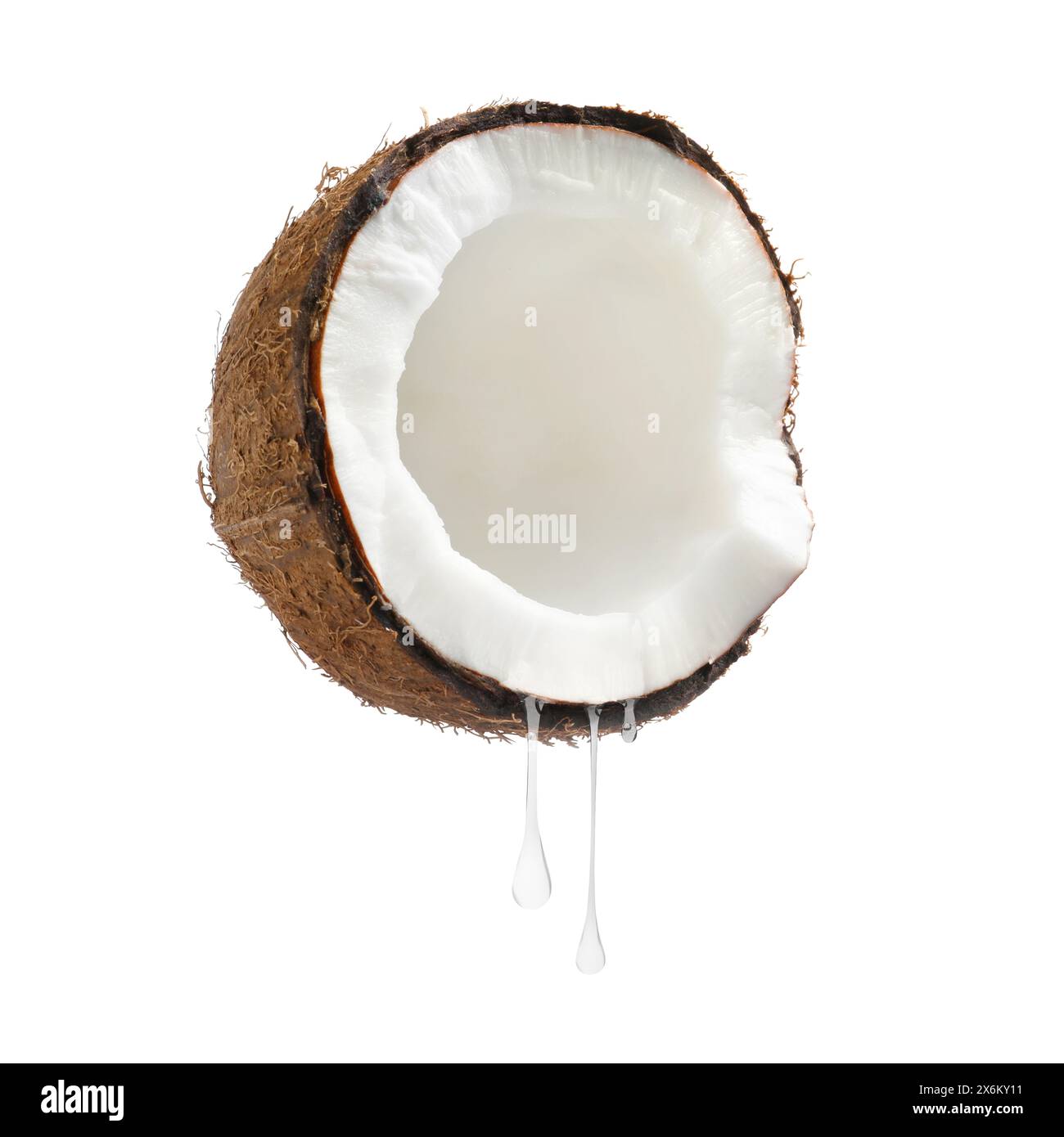 Coconut with dripping oil isolated on white Stock Photo - Alamy