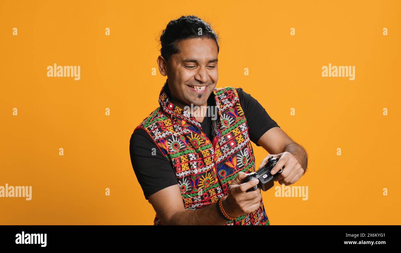 Happy gamer celebrating after winning game on gaming console, studio ...