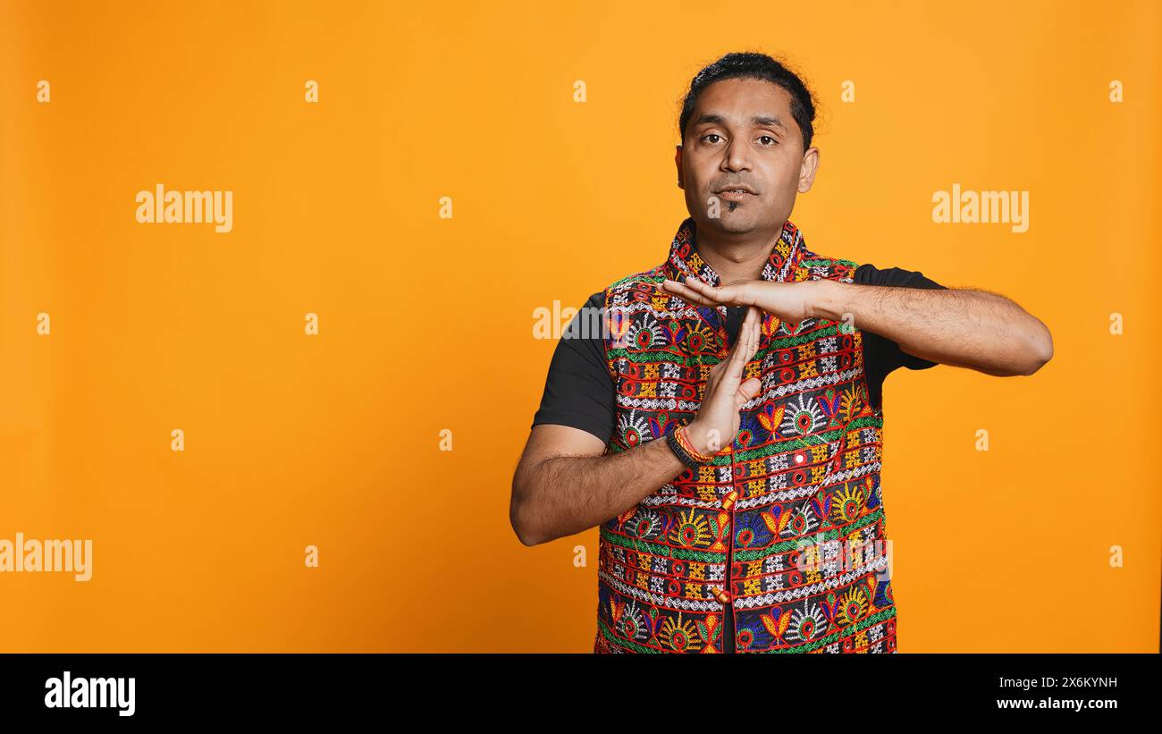 Portrait of assertive indian man asking for timeout, doing hand ...