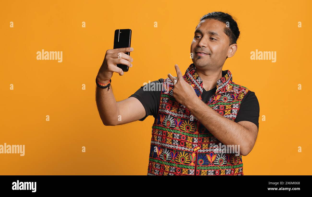 Indian narcissistic man using cellphone to take selfies from all angles ...
