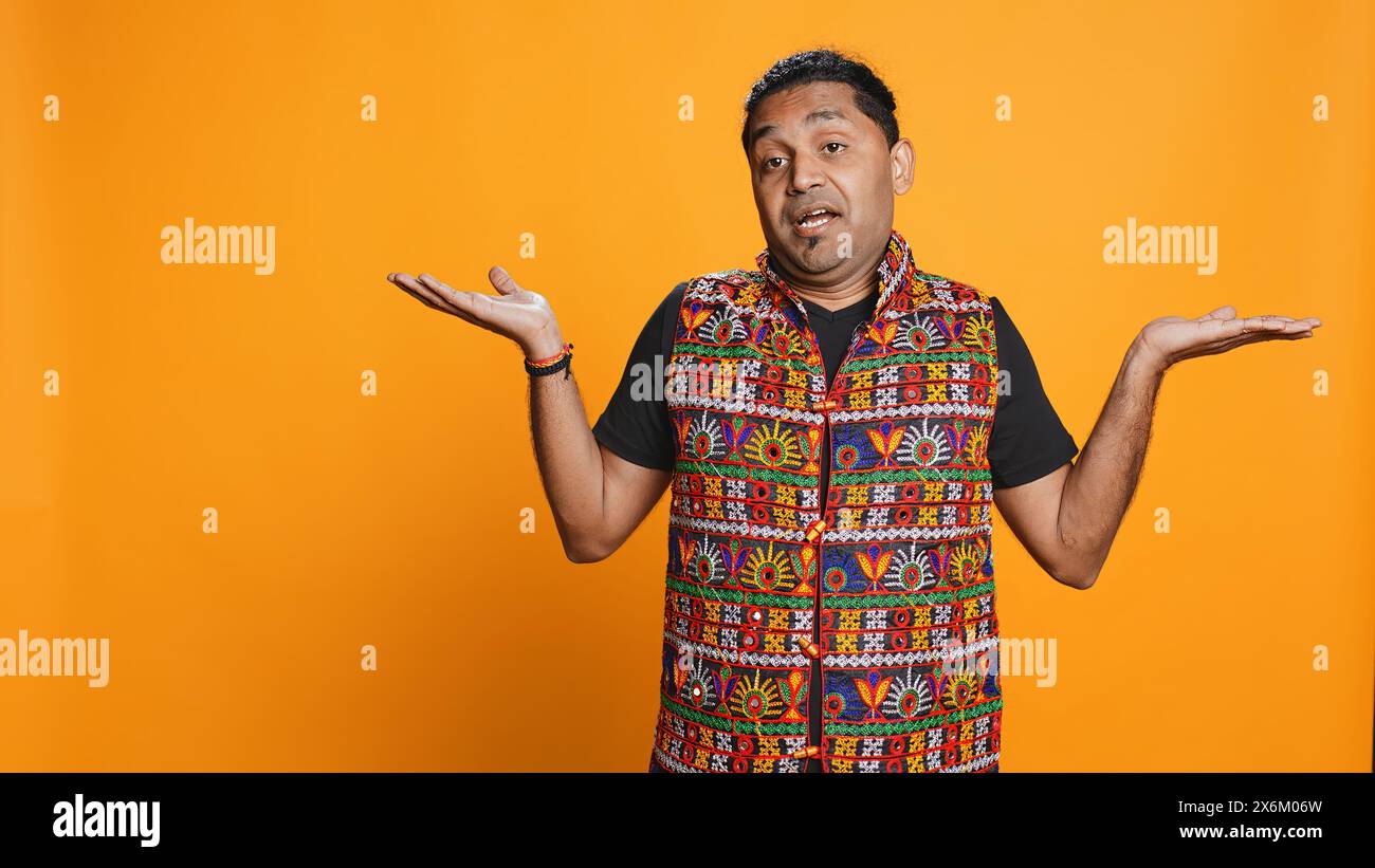 Indian man shrugging shoulders, unable to provide answer, having ...
