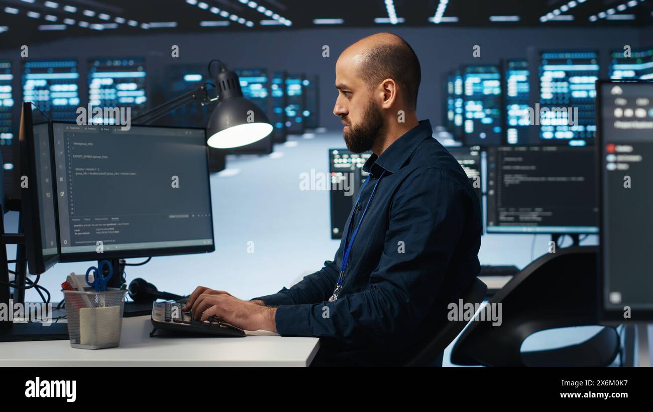 IT specialist in server farm ensuring valuable data remains shielded from potential threats ...