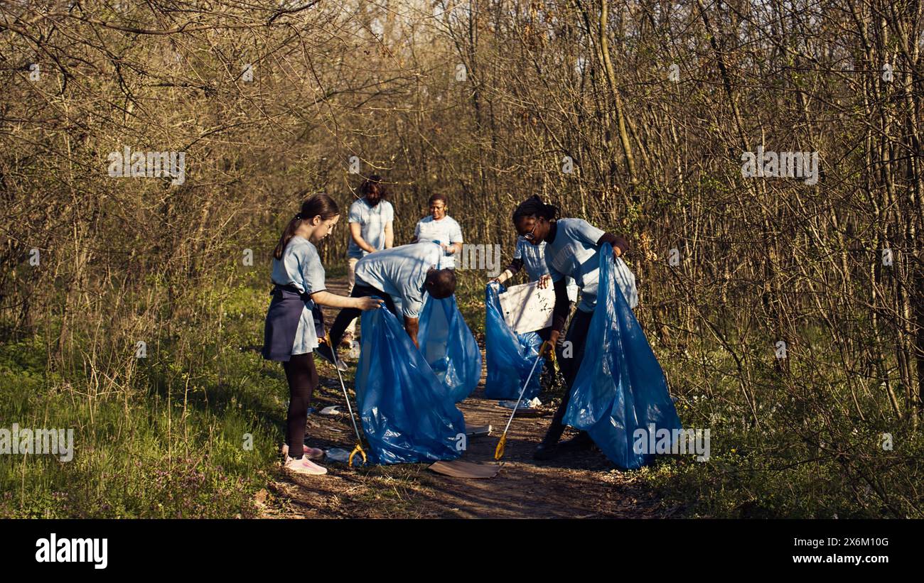 Group of volunteers working to clean the forest from garbage ...