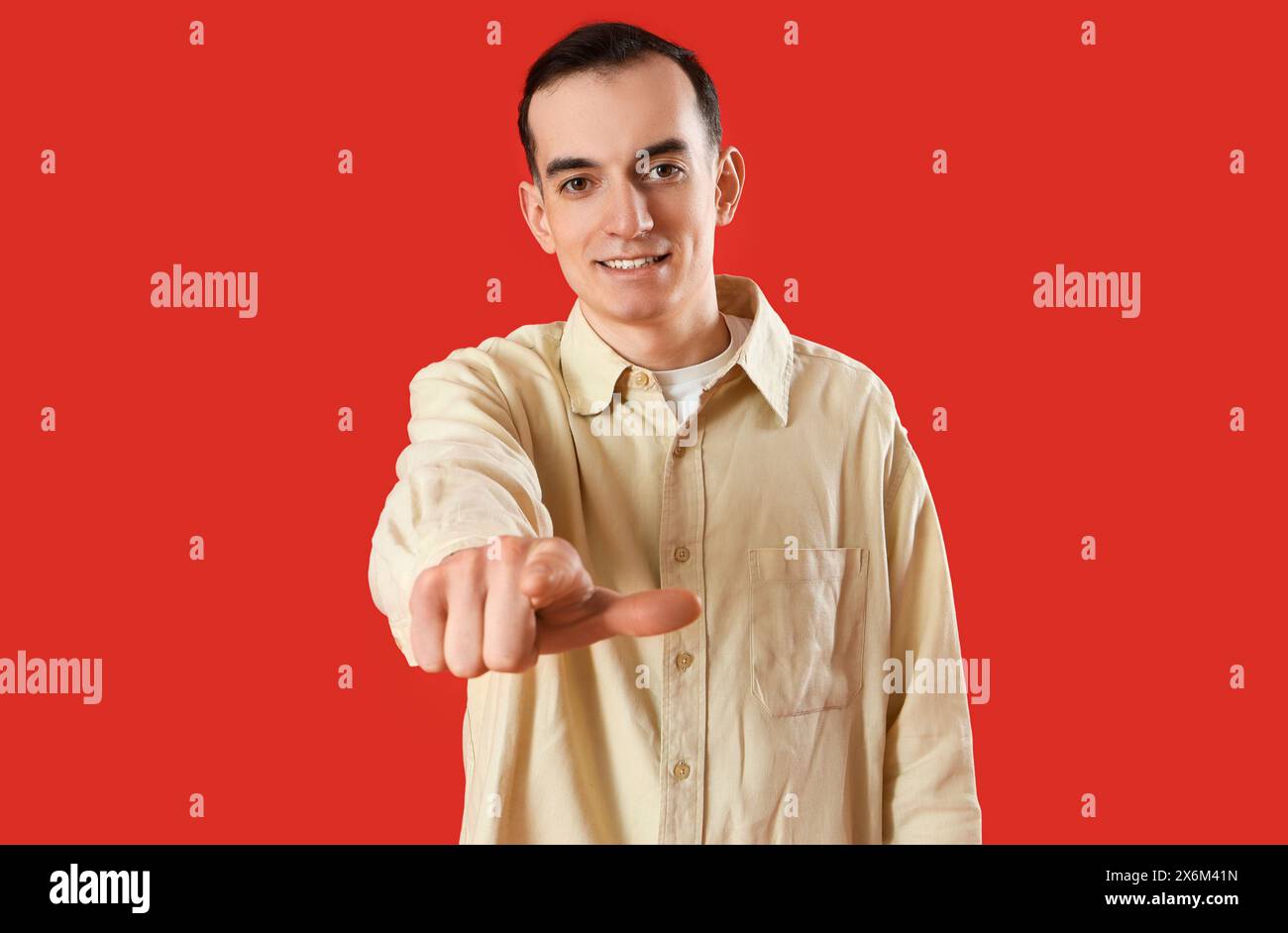 Positive young man pointing viewer hi-res stock photography and images ...