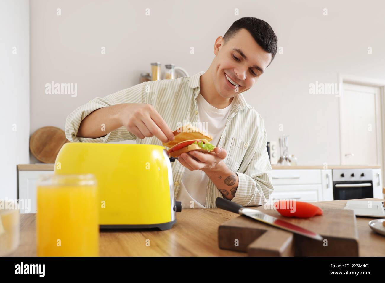 Man preparing tasty toasts hi-res stock photography and images - Alamy