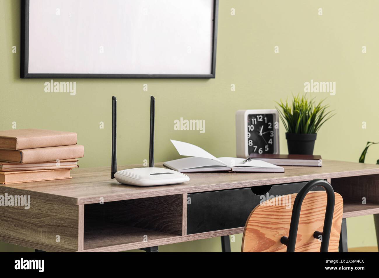 Workplace with wi-fi router and books in office Stock Photo - Alamy